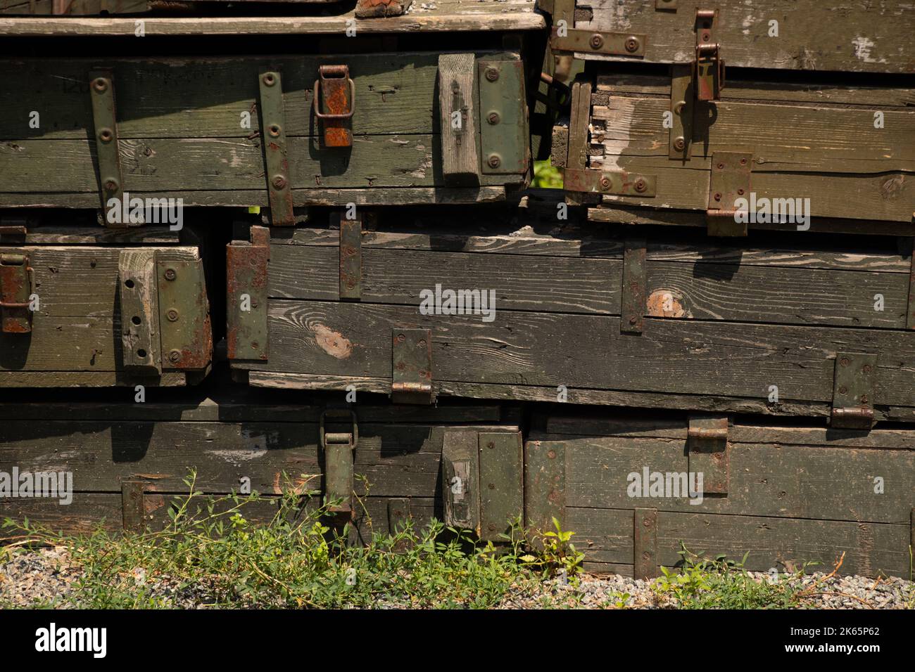Old green wooden weapon boxes stand outside in the sun,arms depot Stock ...