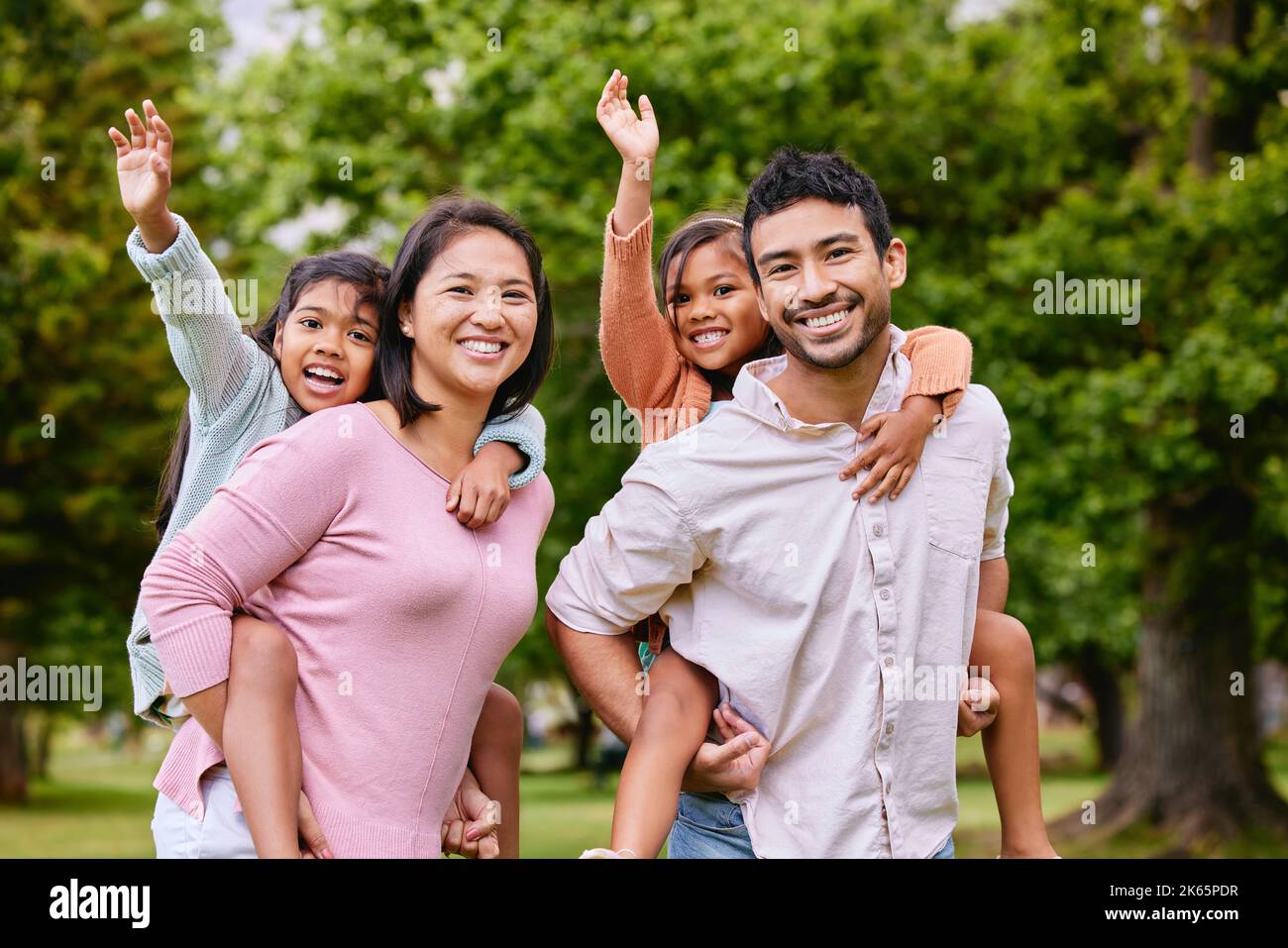 Mixed race family in the park. Happy young mother and father ...