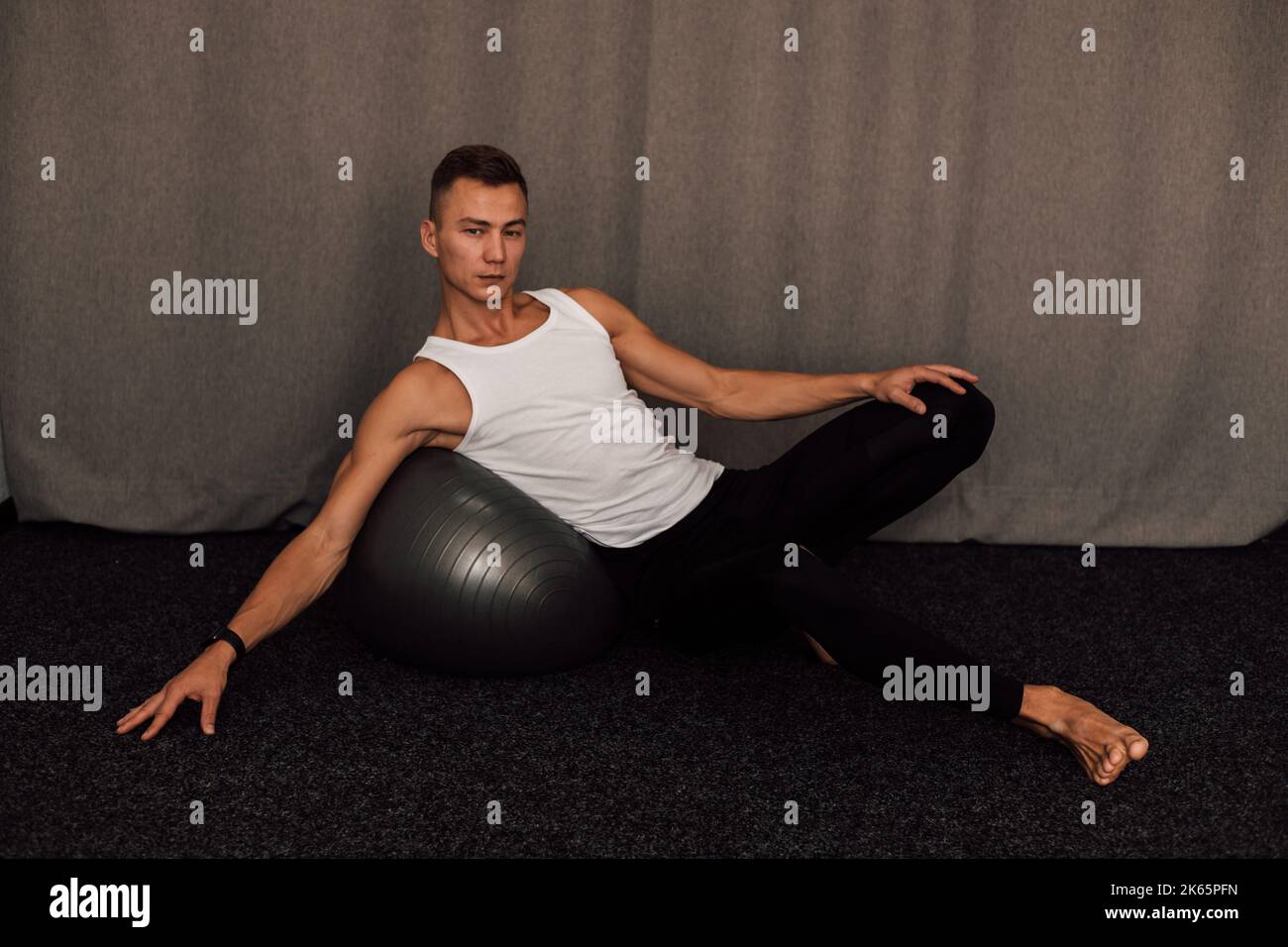 A young athlete performs exercises at home. Fitness Fitball Yoga ...