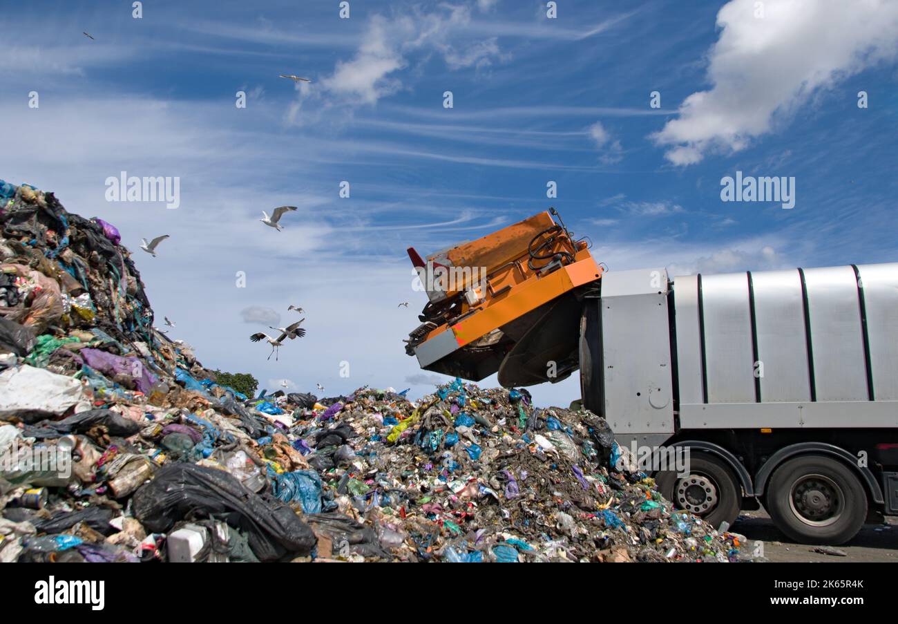 Landfill waste disposal. Garbage truck unloads rubbish in landfill ...
