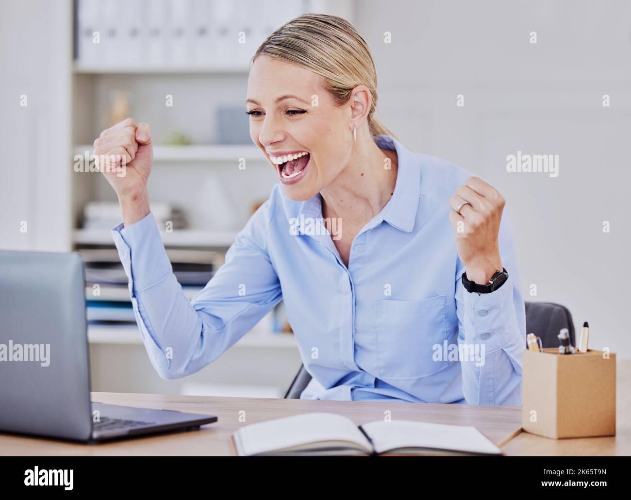 Cheerful young caucasian business woman celebrating her success ...