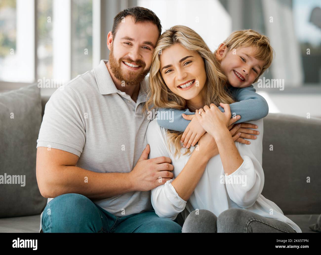 Happy caucasian family of three looking relaxed while sitting and ...