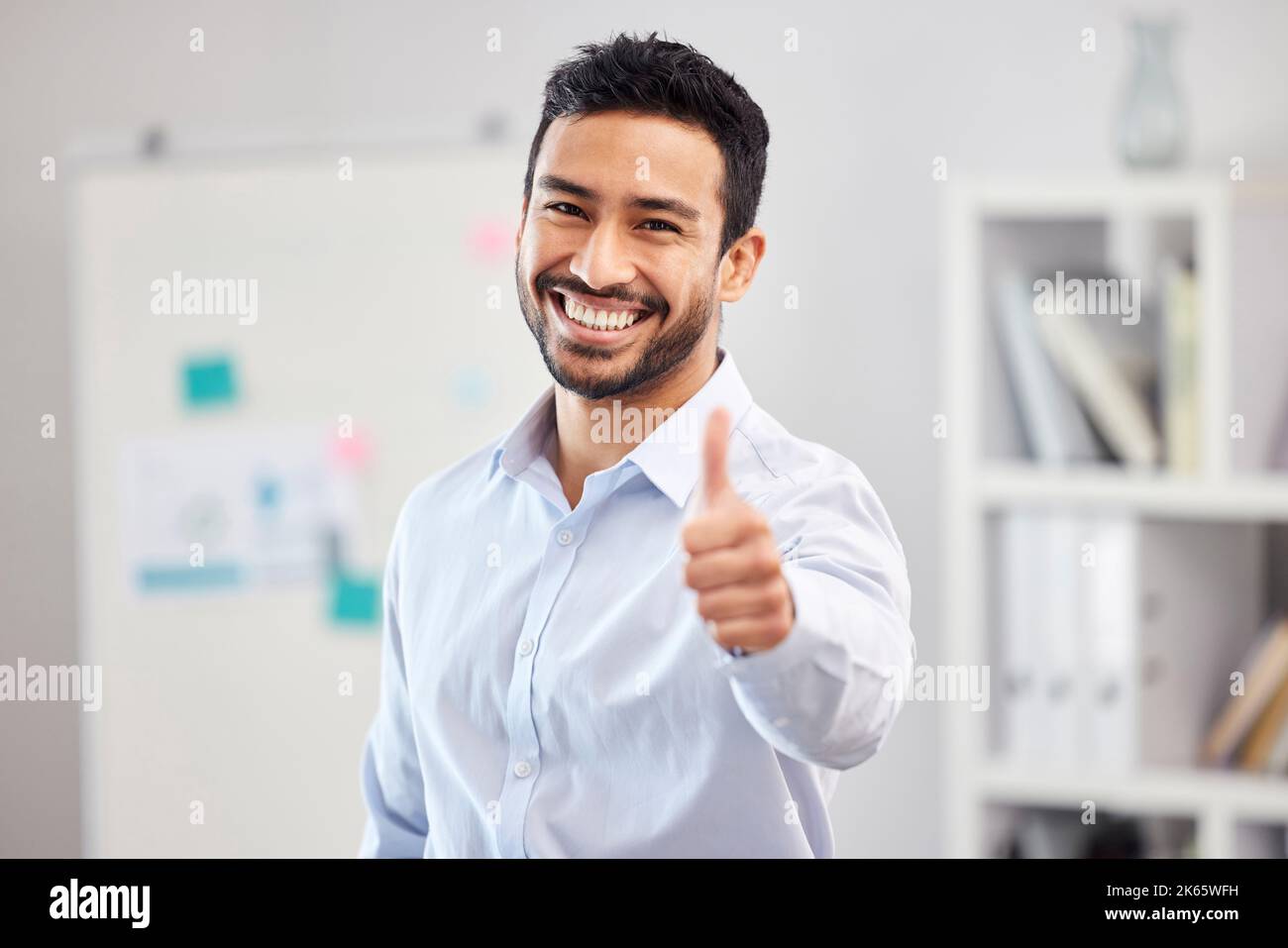 Young happy handsome mixed race businessman showing a thumbs up ...