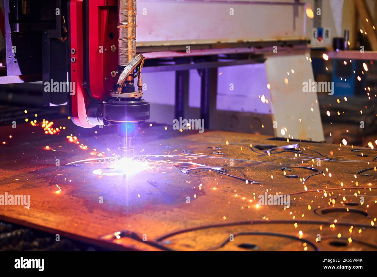 Plasma cutting of metal plate with flying sparks in workshop Stock ...