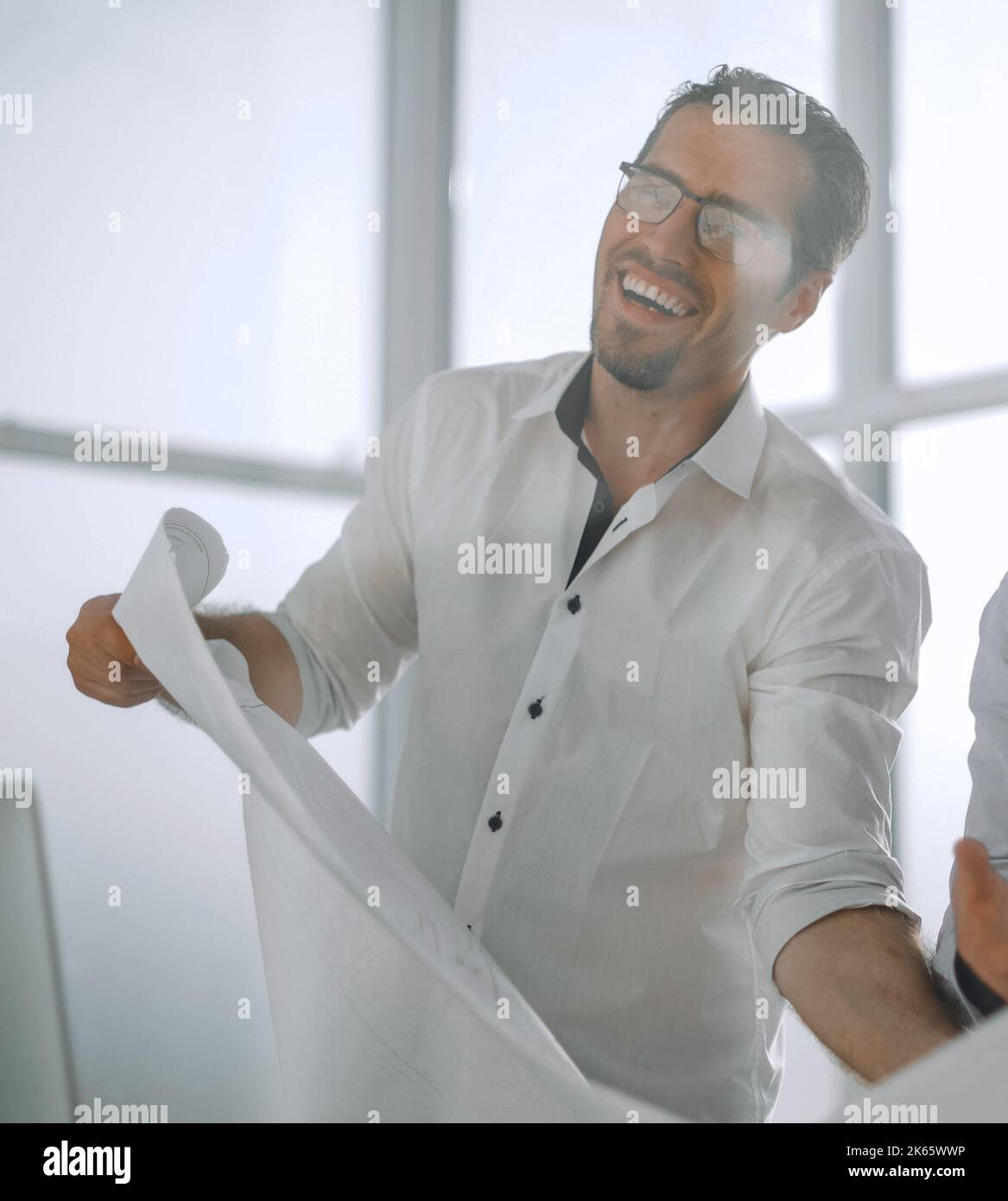 employees discussing drawings for new project Stock Photo - Alamy
