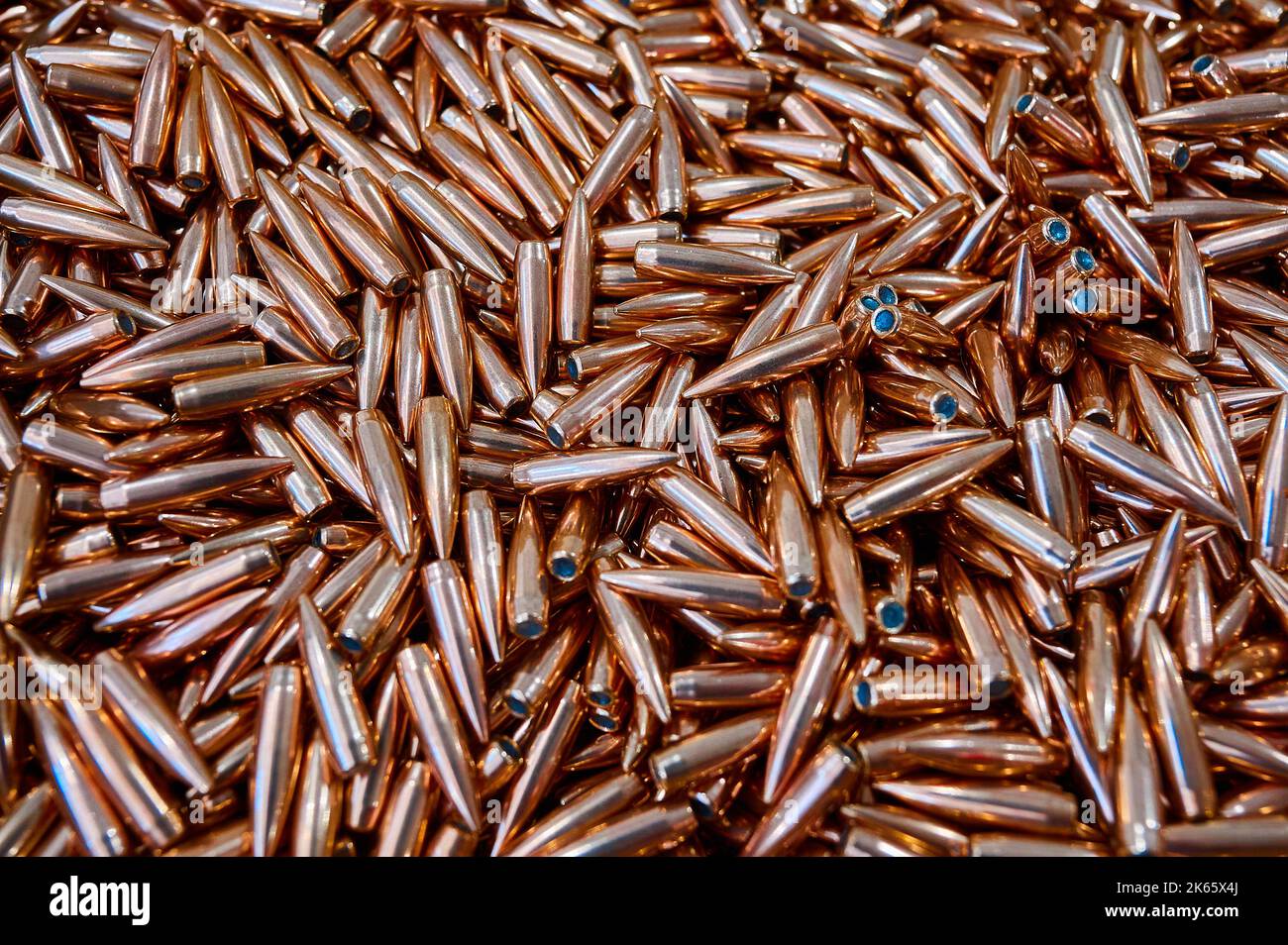 Glowing large caliber bullet heap for riffle as background Stock Photo ...