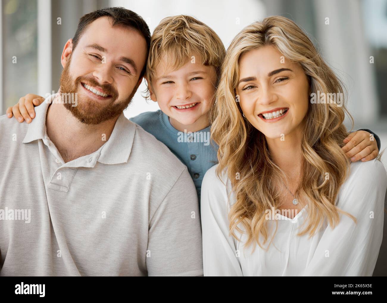 Portrait of happy parents and their little son at home. Adorable ...