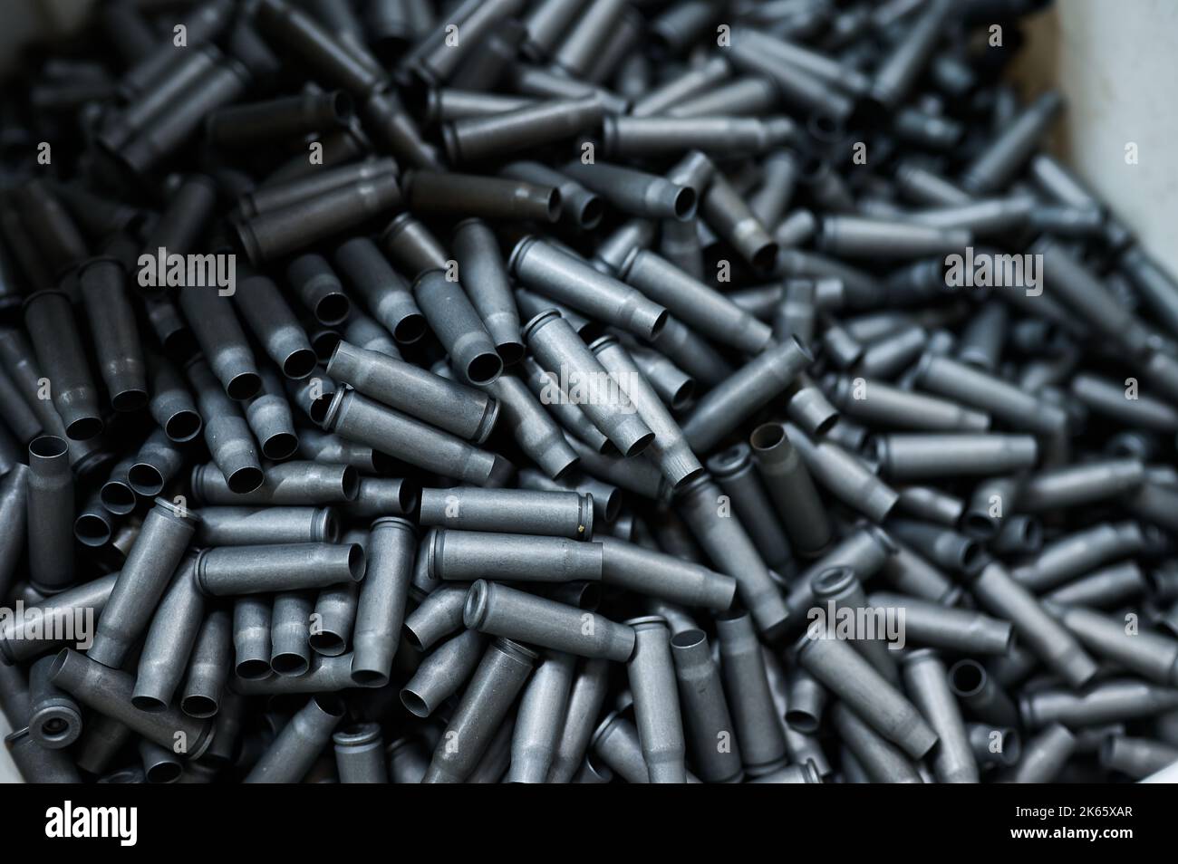 Grey shell casings in container at armor production plant Stock Photo ...