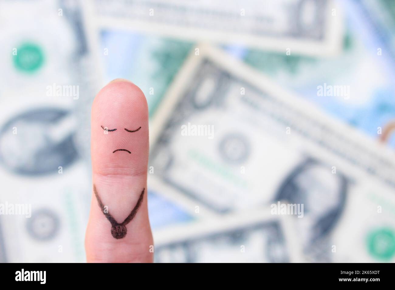 Finger art of a lonely sad man on the background of money Stock Photo ...