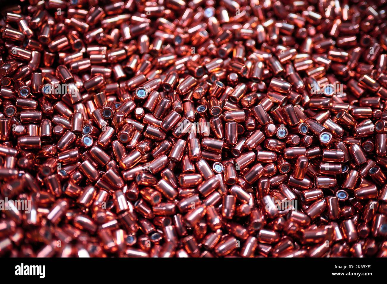Brass metal bullets pile for weapons as background Stock Photo - Alamy