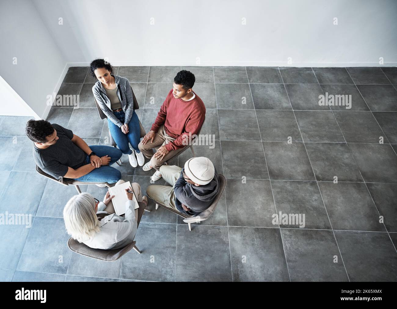 Above group therapy. Therapist talking to patients together. Group of ...