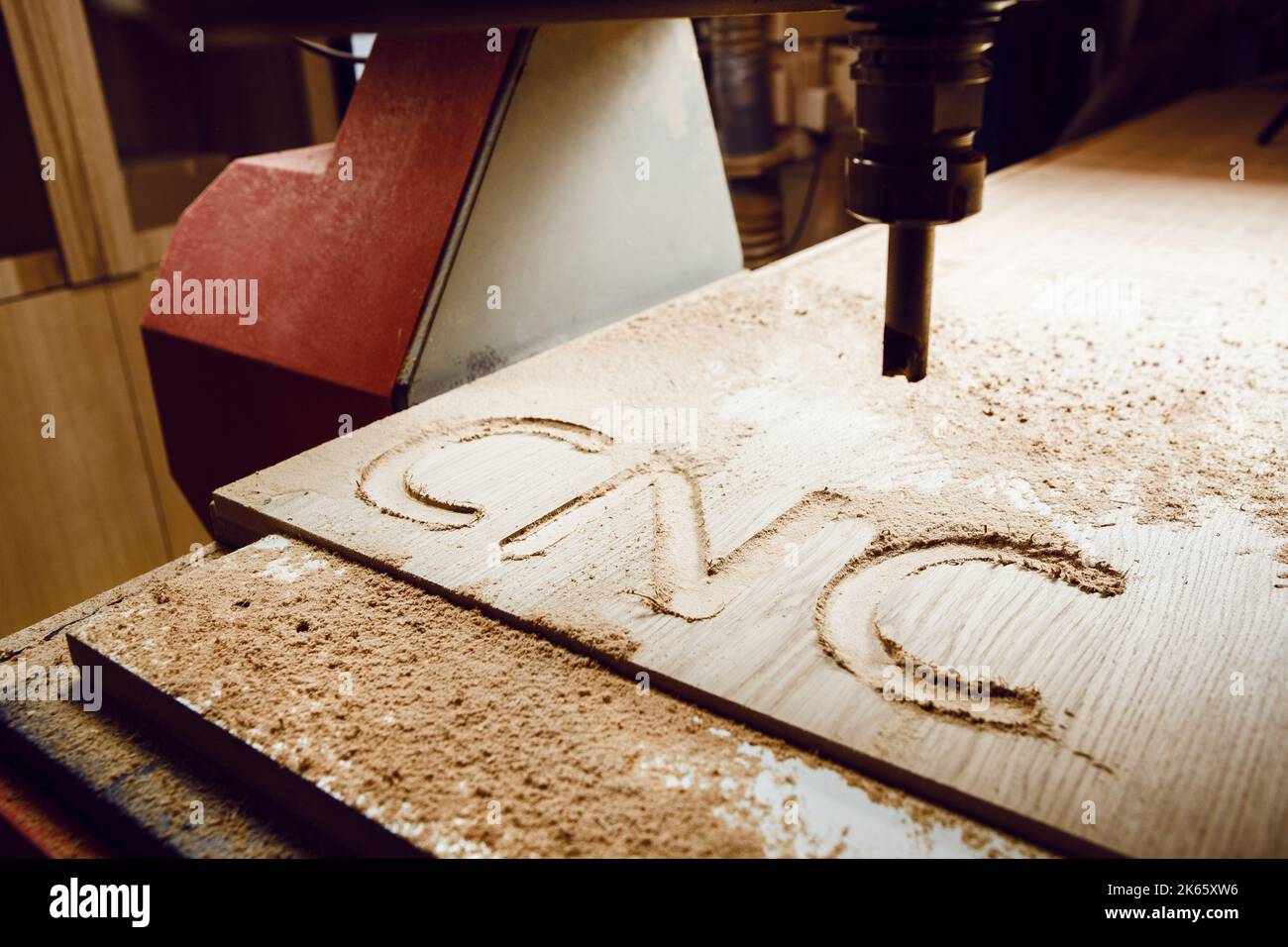 Cnc machine at carpentry workshop. Cutting wood with various router ...