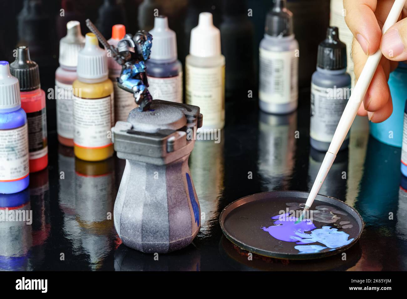 A person painting figures of warriors used to participate in role ...