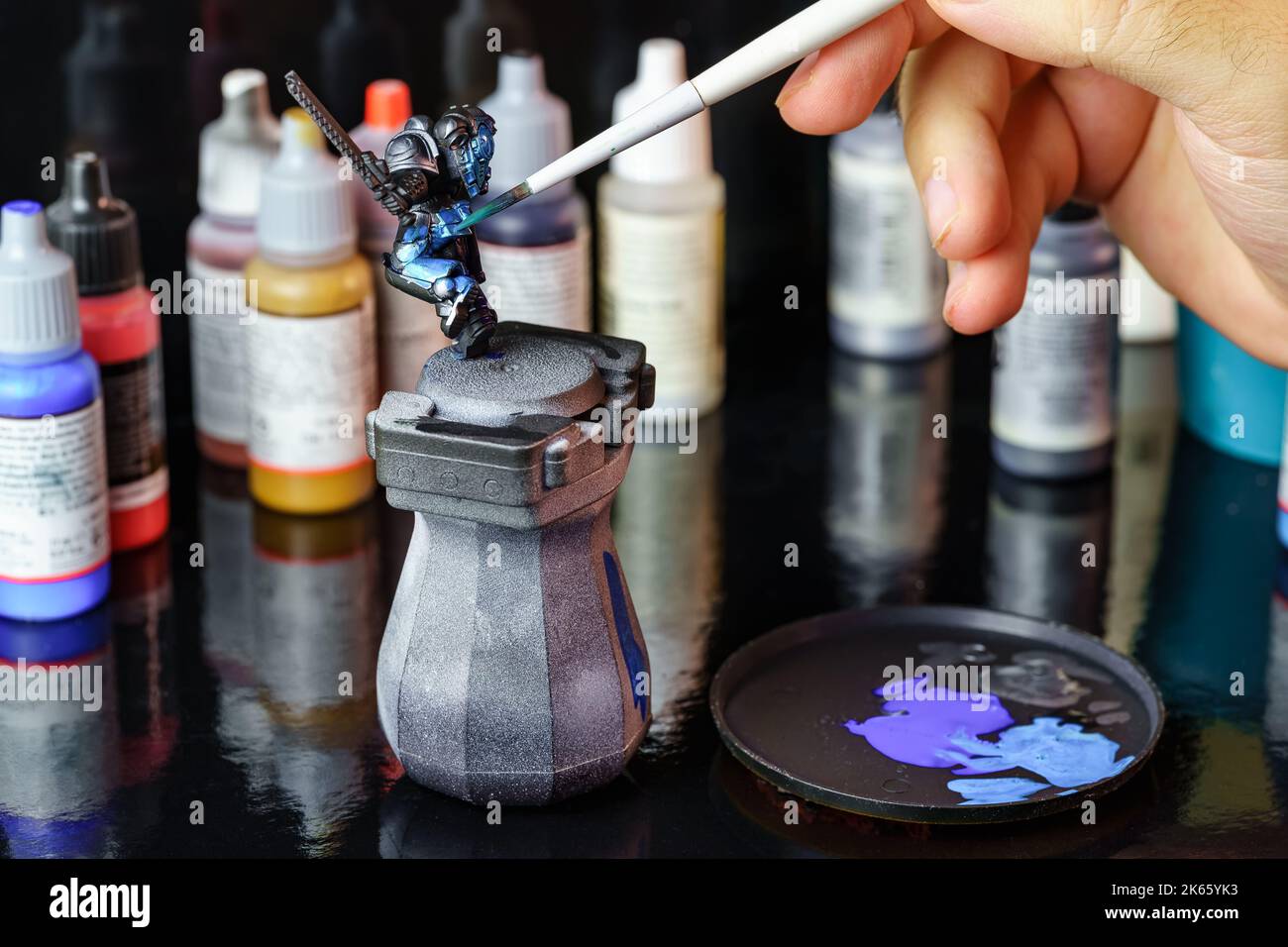 Person painting a small role-playing game figure for board games Stock ...