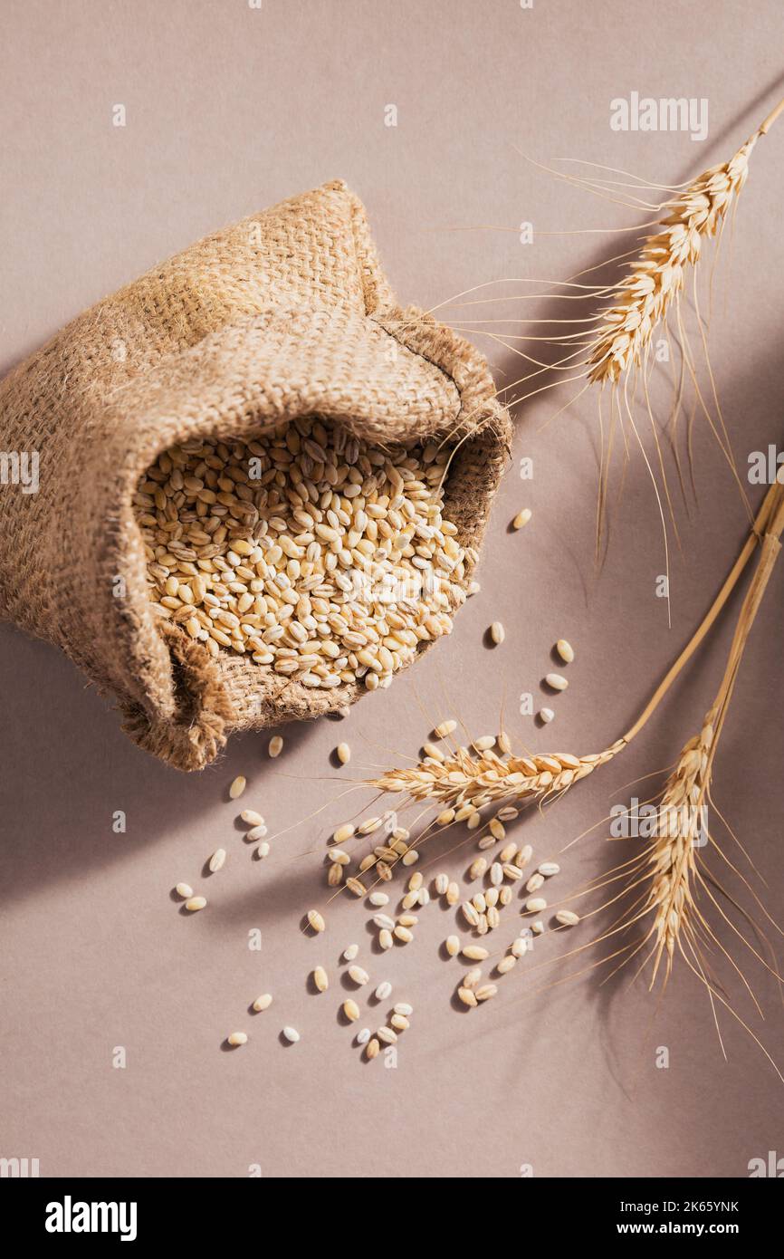 Burlap bag of dry raw broken pearl barley cereal grain Stock Photo - Alamy