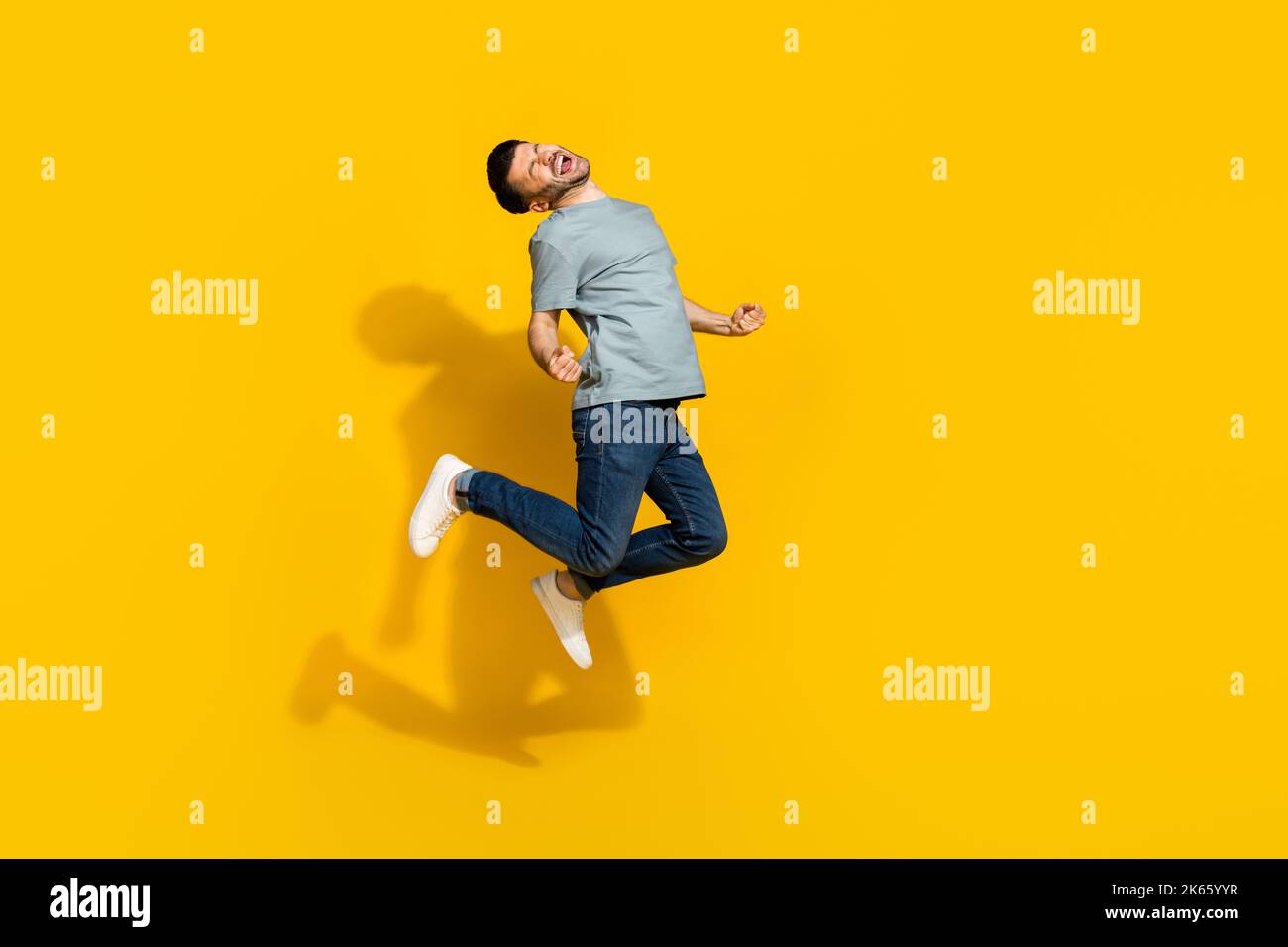 Full length portrait of delighted astonished man jumping celebrate ...