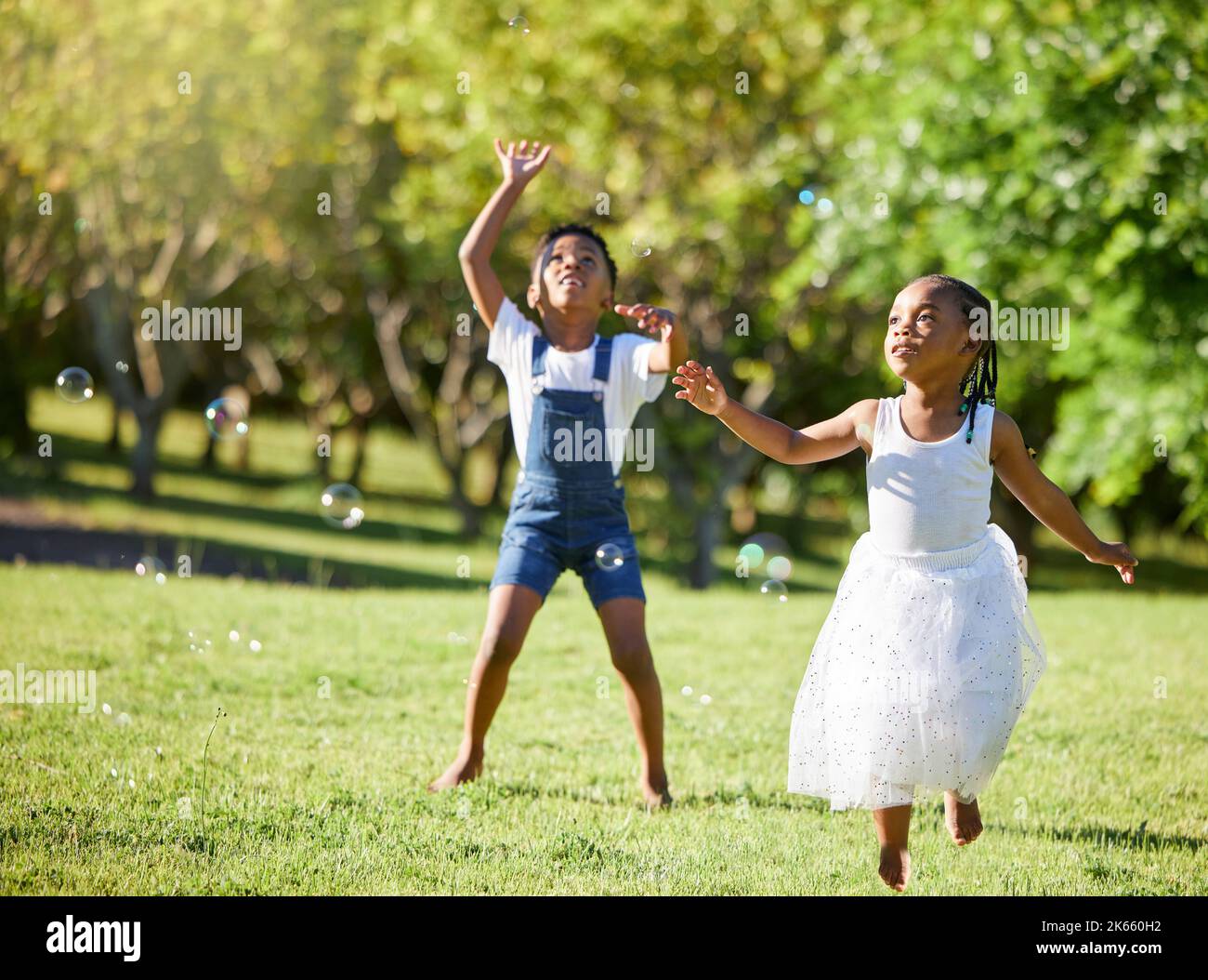 The world is our playground. an adorable little girl and boy playing ...
