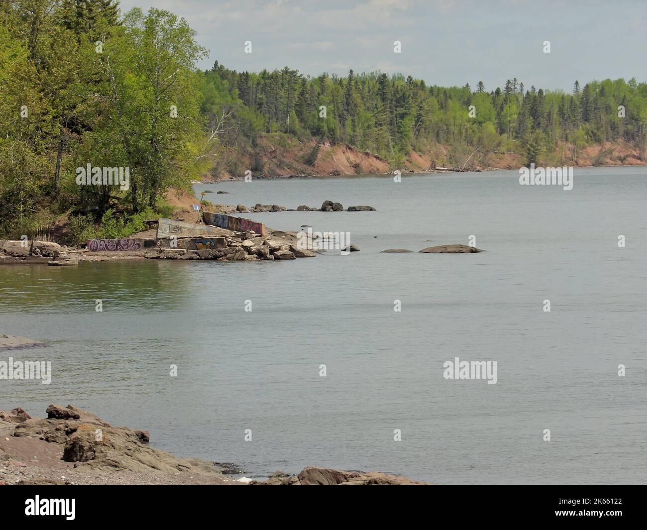 A tall trees on the island with calm sea water Stock Photo - Alamy