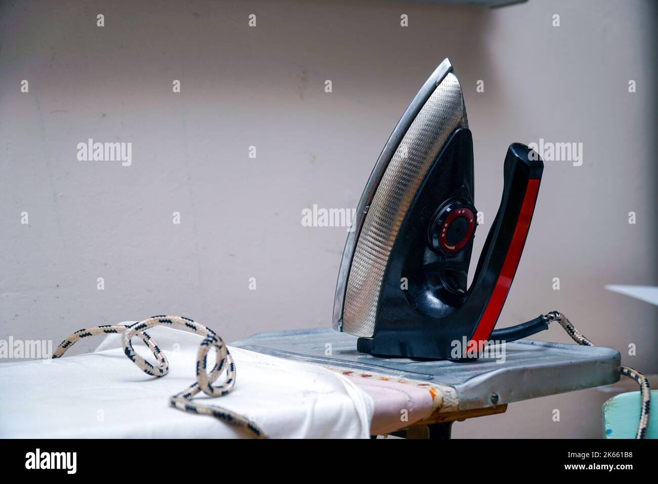 Old electric iron on the ironing board Stock Photo - Alamy