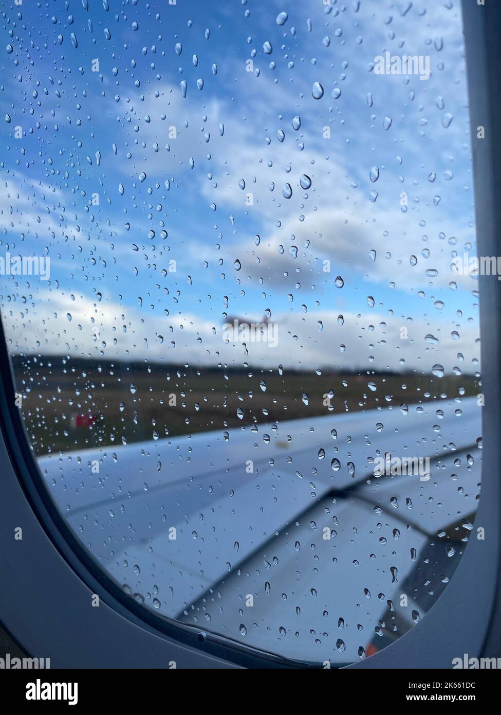 A vertical shot of water drops on an airplane window Stock Photo - Alamy