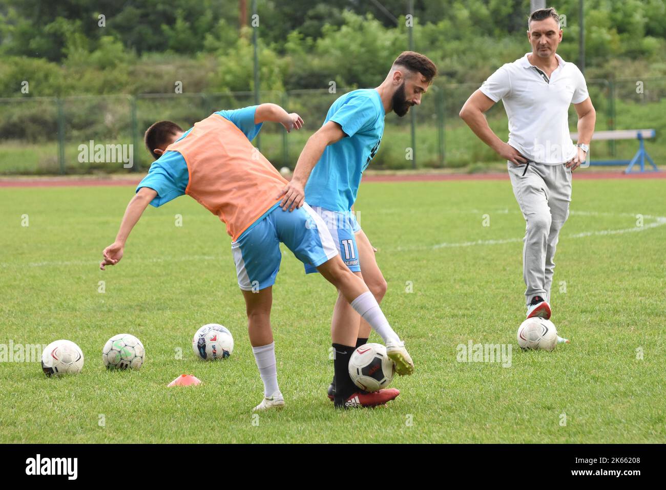 A group of football players playing on a field Stock Photo - Alamy