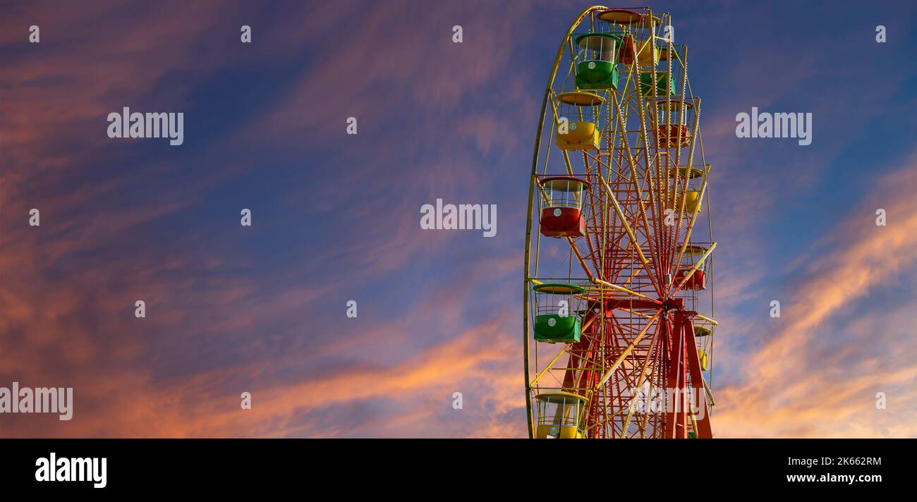 Attraction (carousel) ferris wheel against the background of a romantic ...