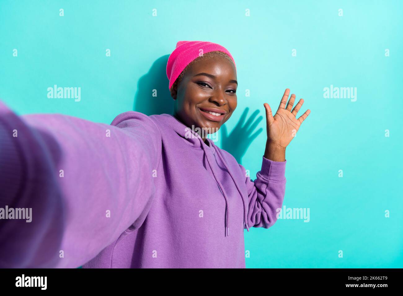 Self portrait of attractive cheerful girl waving hi hello good mood ...