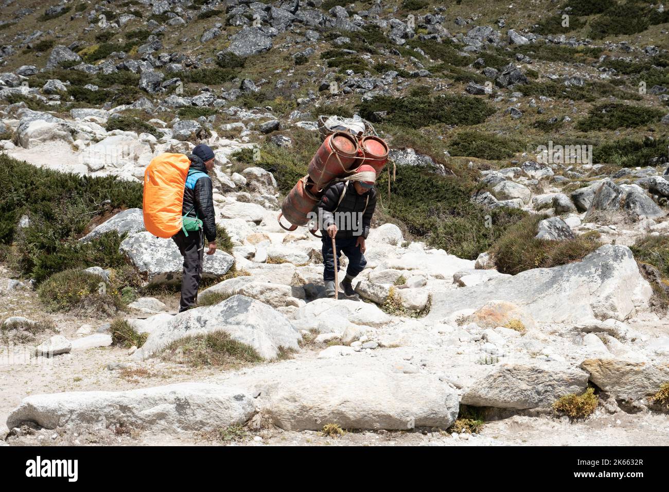 Shepa carrying heavy gas cylinder in Nepal on the Everest Way Stock ...