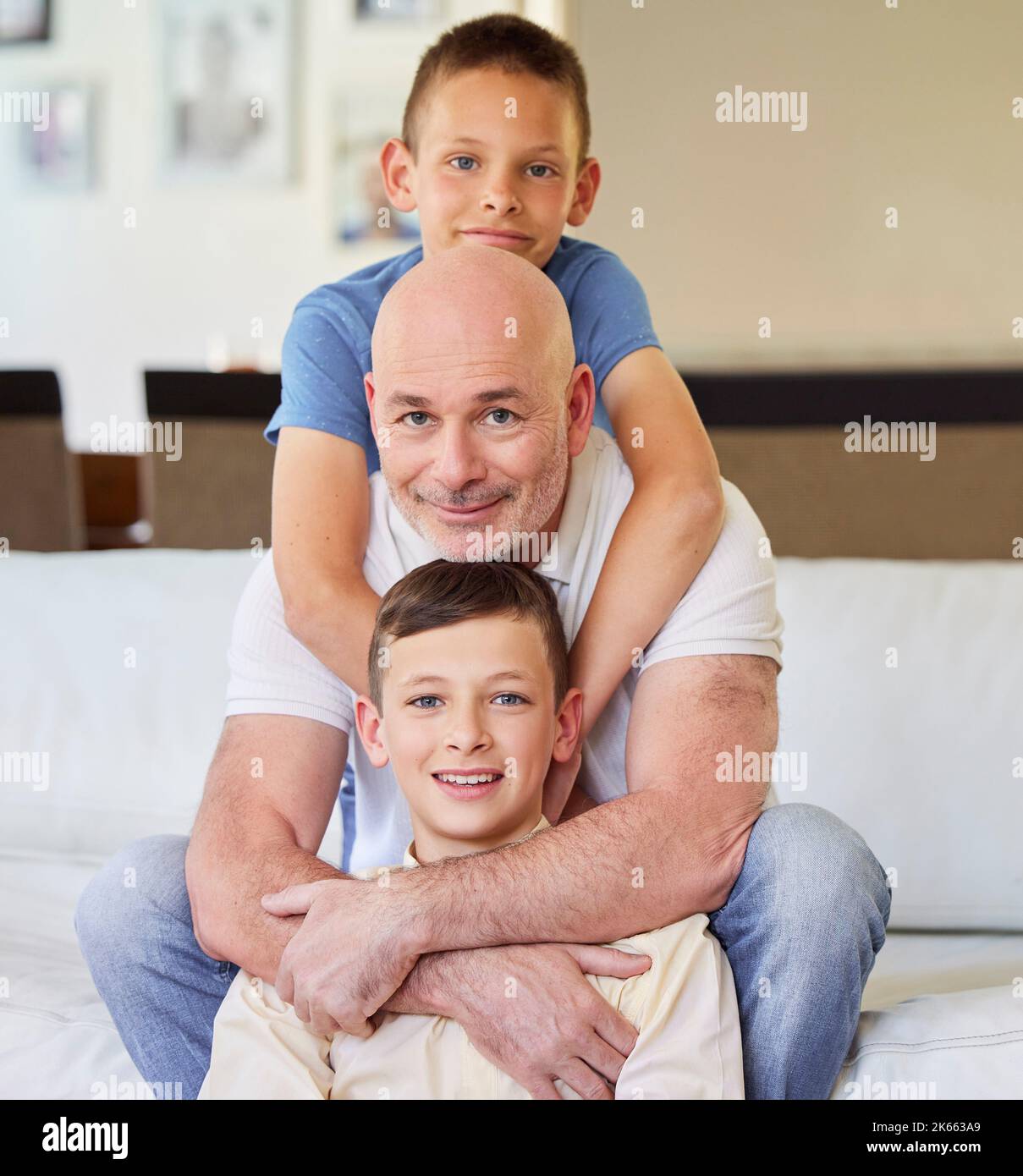 Portrait of a young caucasian father spending time with his two sons at ...