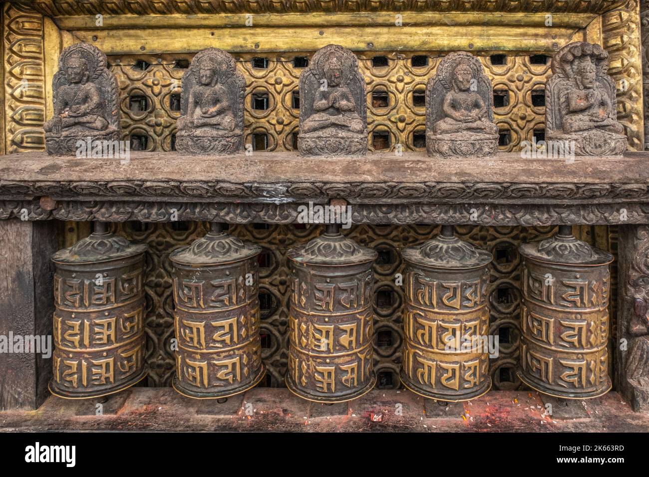 Buddist Prayer wheels with carvings of Buddah above Stock Photo - Alamy