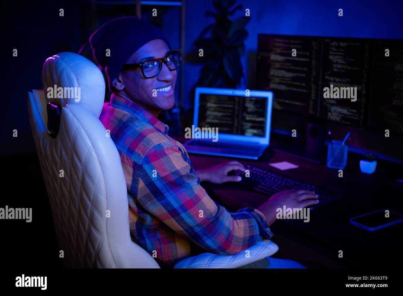 Profile portrait of cheerful hacker guy sitting chair keyboard typing ...
