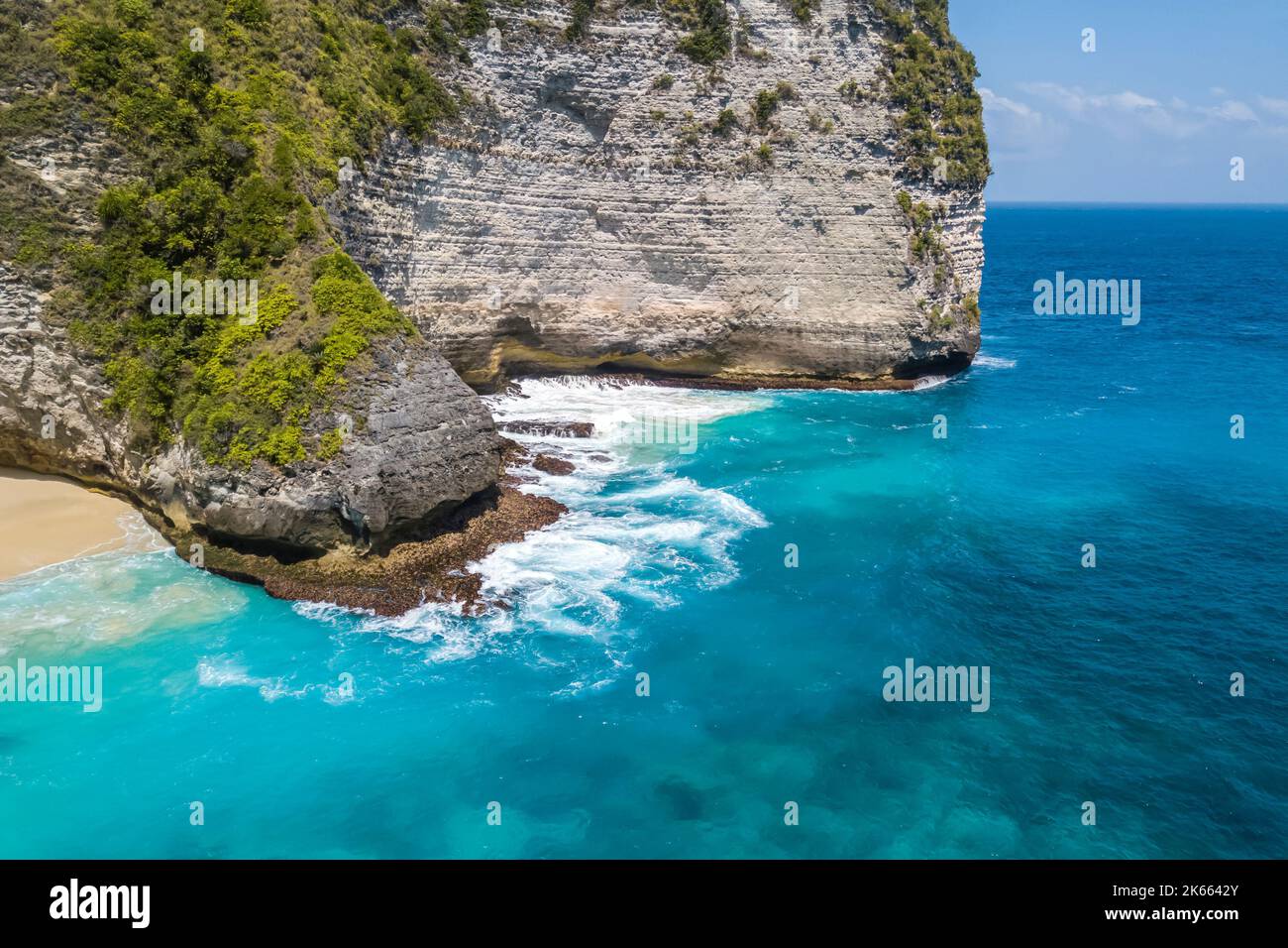 Nusa Penida Island, Kelingking Beach. Top view aerial view of a sandy clean beach with clear ...