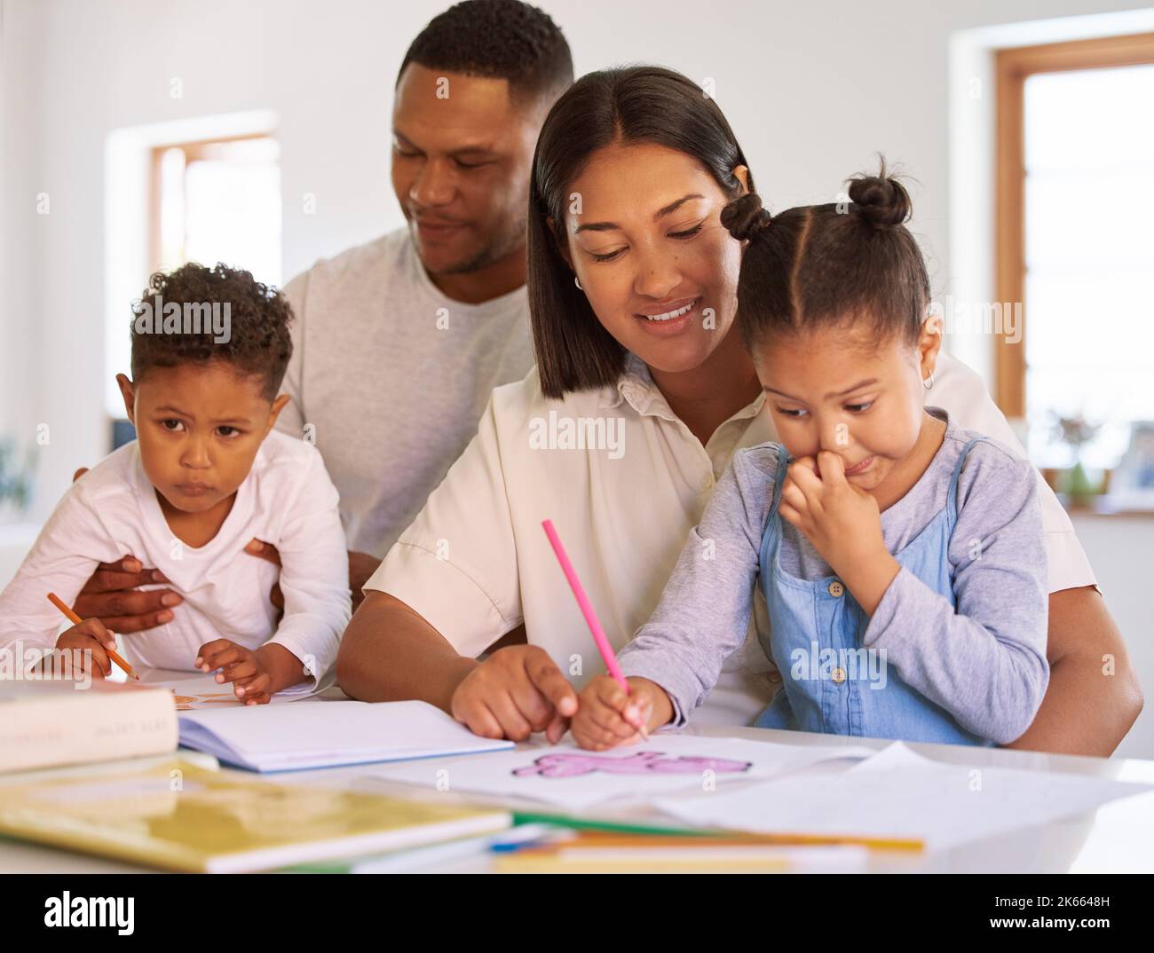 Boy and girl learning and studying through homeschool with mom and dad ...