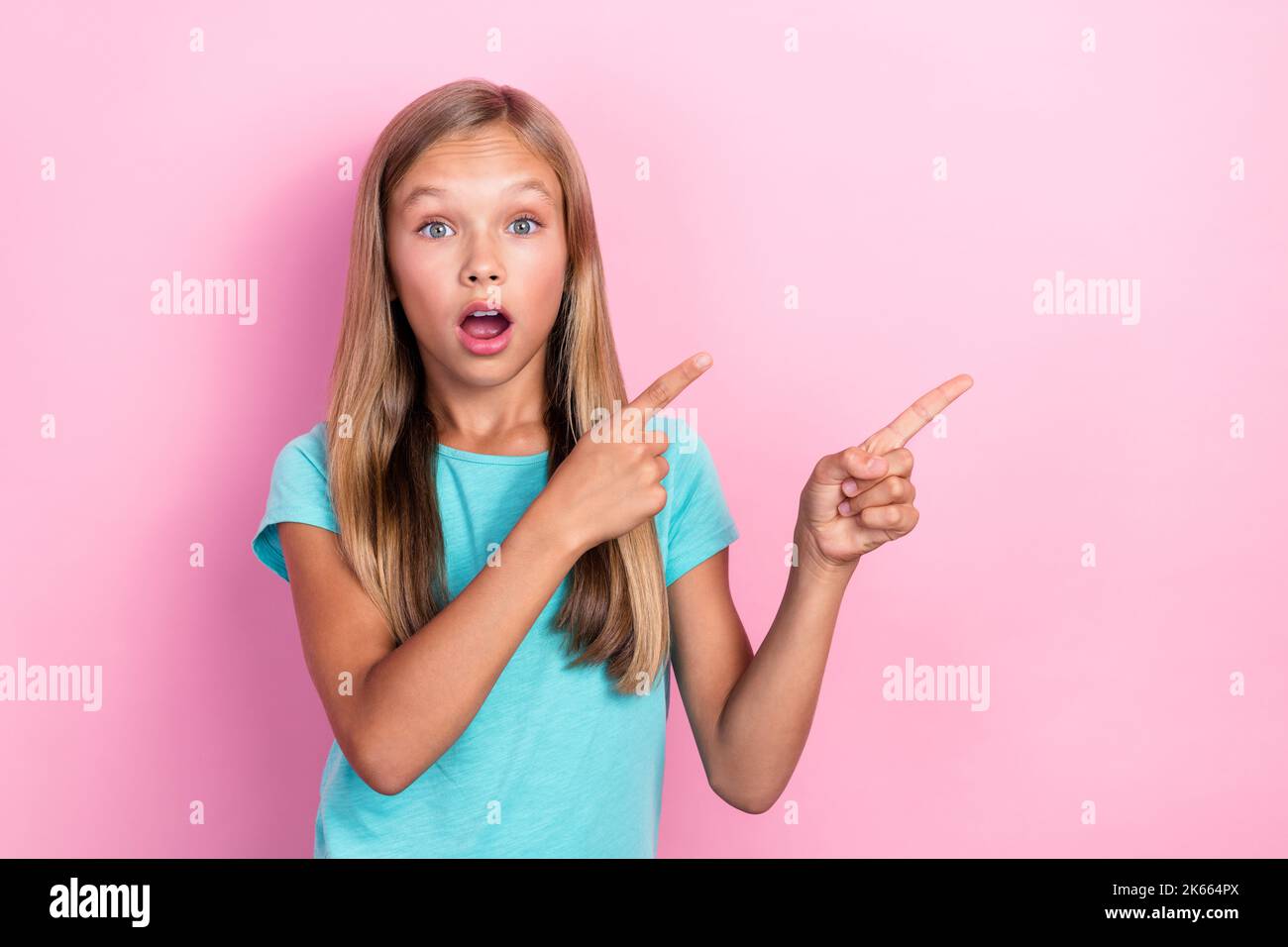 Photo of impressed funky little child dressed teal t-shirt pointing two ...