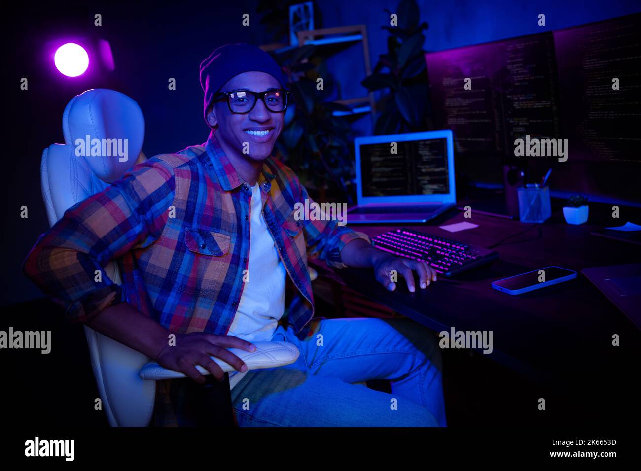 Profile photo of cheerful hacker guy sit chair operating research night ...