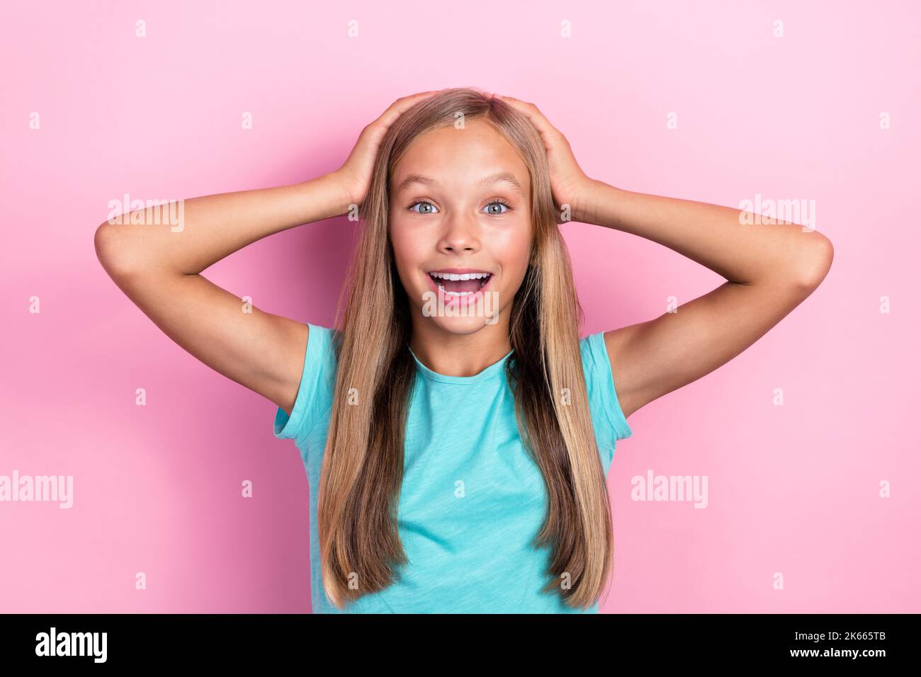 Photo of funky excited little child dressed teal t-shirt pointing arms ...