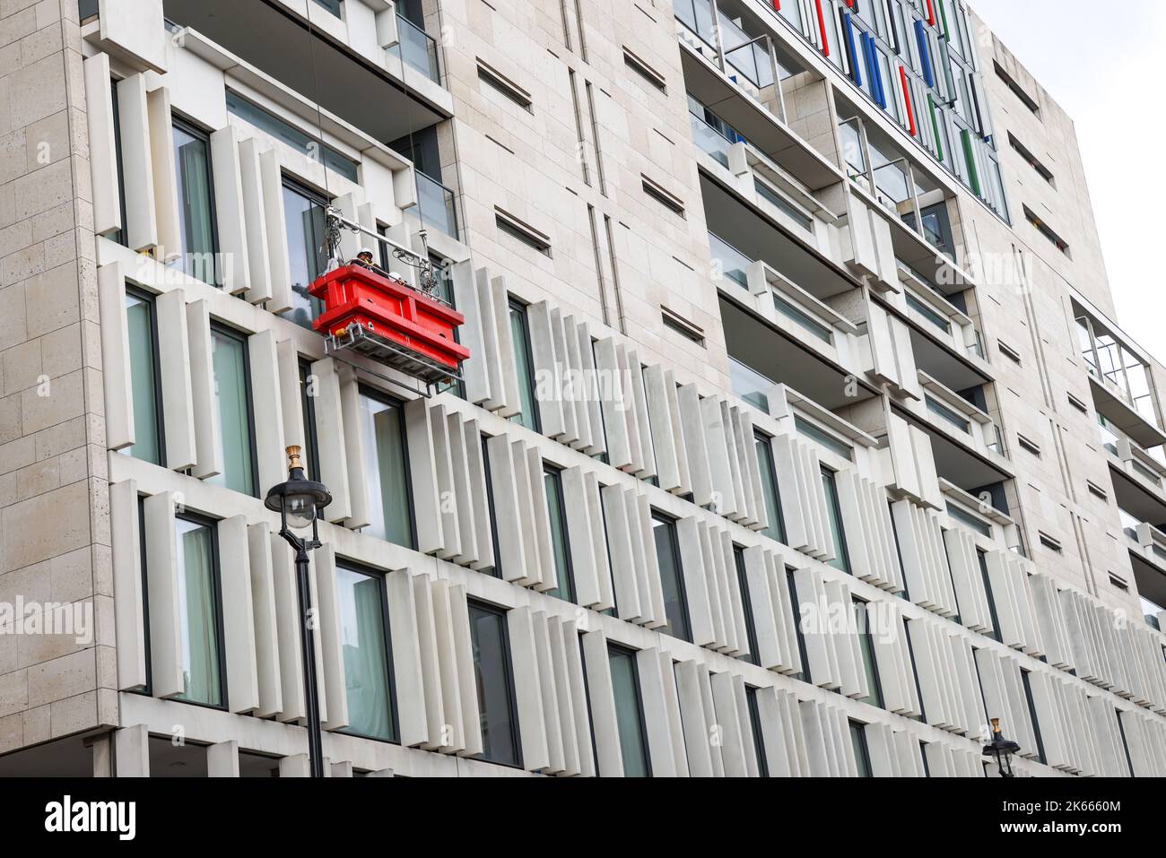 Professional workers use a suspended cradle or steeplejack to access ...