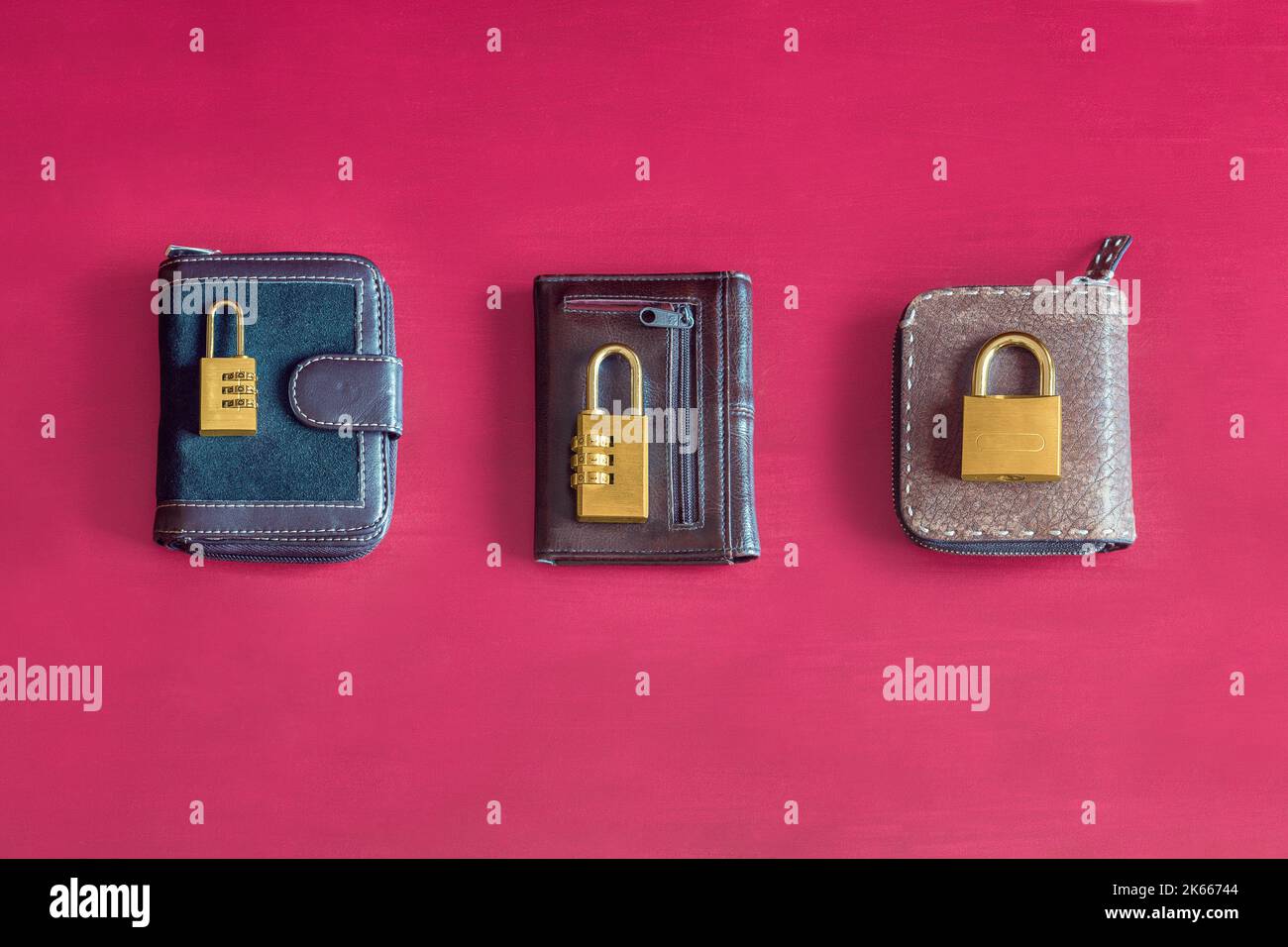 Three different wallets with different golden padlocks and locks on top ...