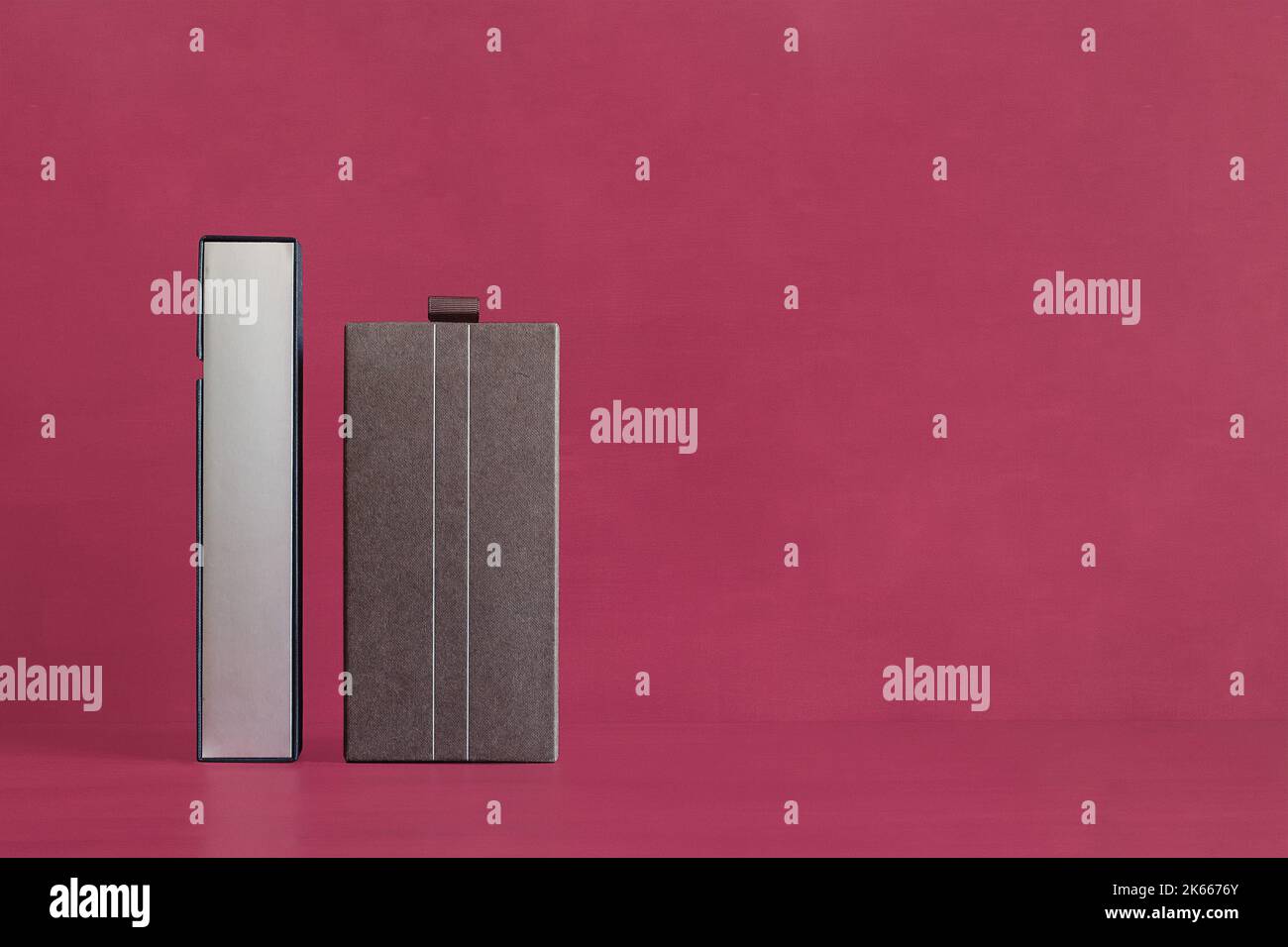 A long thin rectangular box with a silver gray lid next to a vintage ...