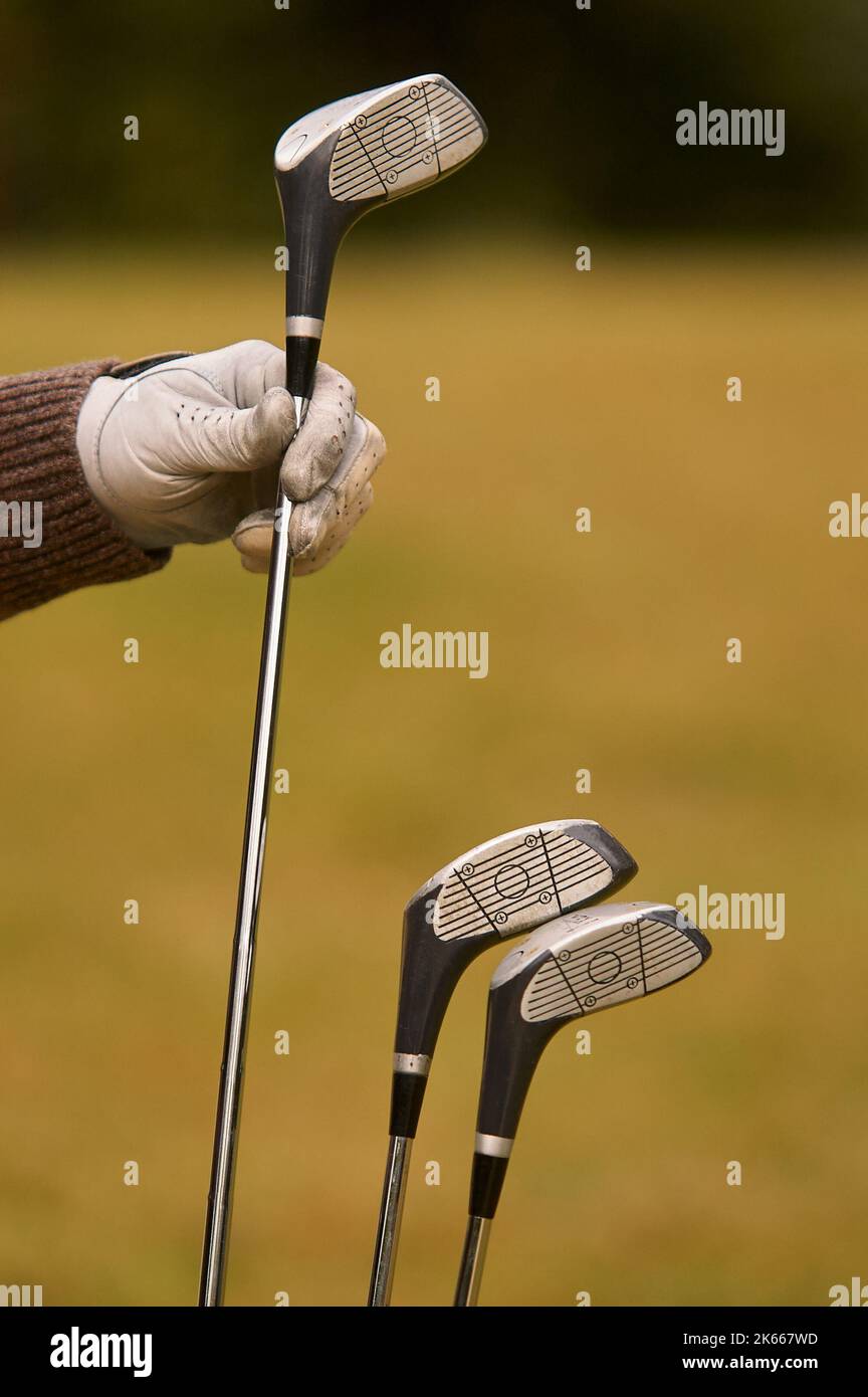 Gloved hand holding golf club Stock Photo - Alamy