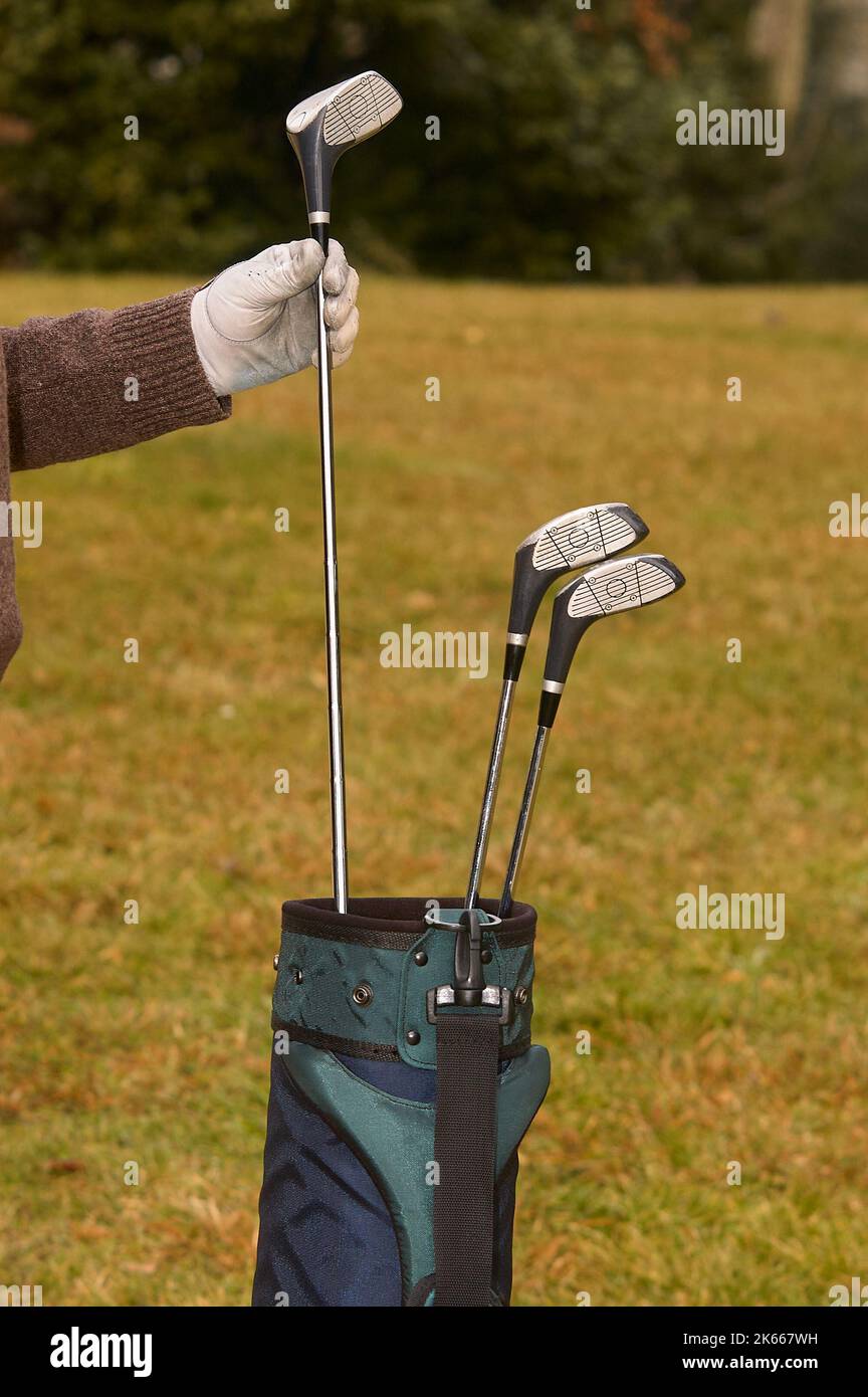 Gloved hand holding golf club Stock Photo - Alamy