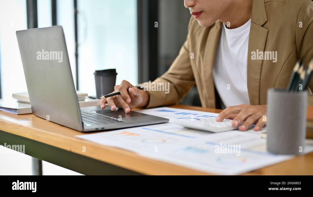 Smart and handsome millennial Asian businessman or male financial ...