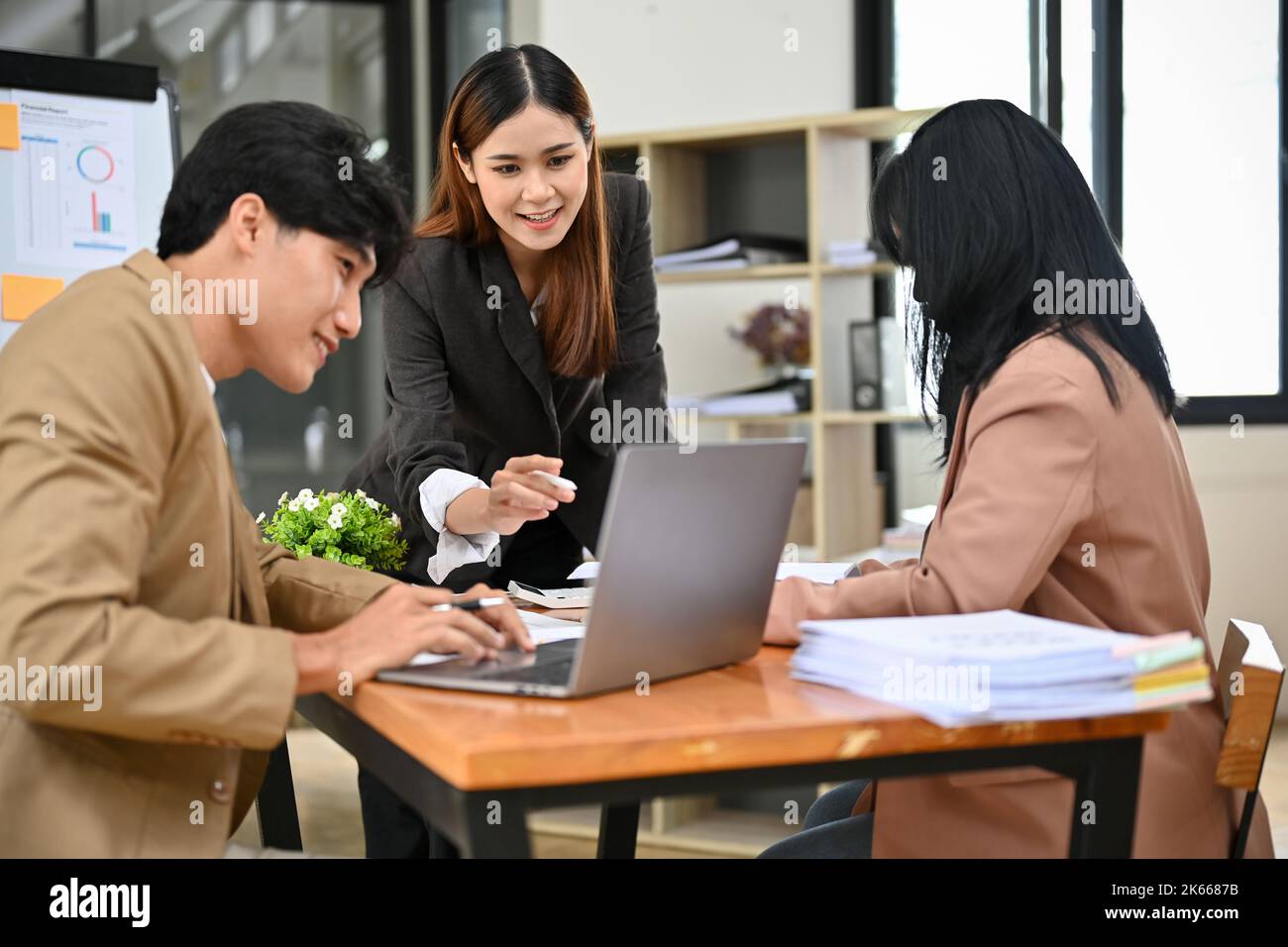 Professional and attractive Asian female manager or boss checking her ...