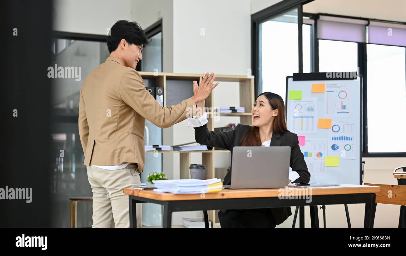 Cheerful and happy young Asian businesswoman or female marketing ...