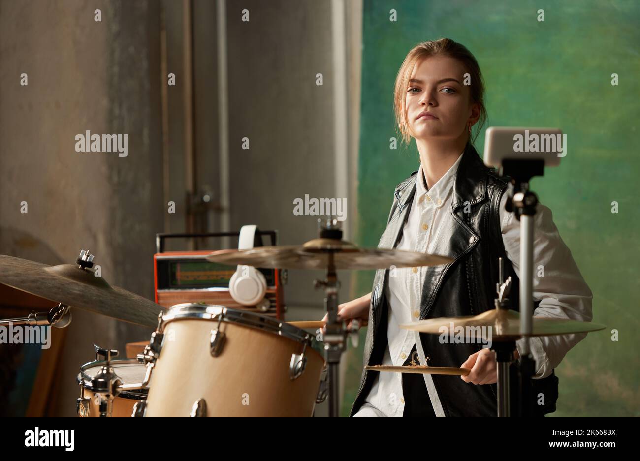 Emotional young girl, rock musician recording music video blog home ...