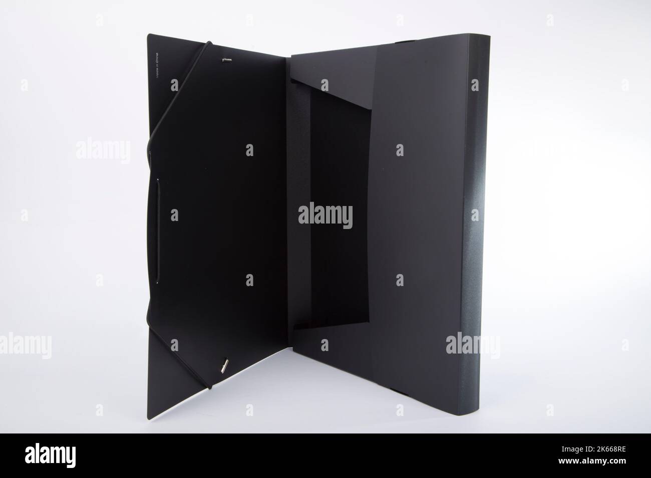 An open black empty plastic file cover folder isolated on white ...