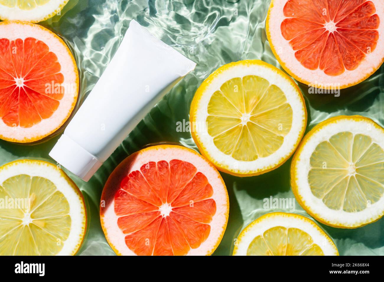White beauty product sunscreen cream vial tube bottle with fruit citrus ...