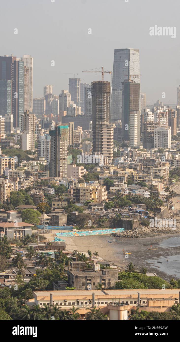 An aerial view of cityscape Mumbai surrounded by buildings and water ...