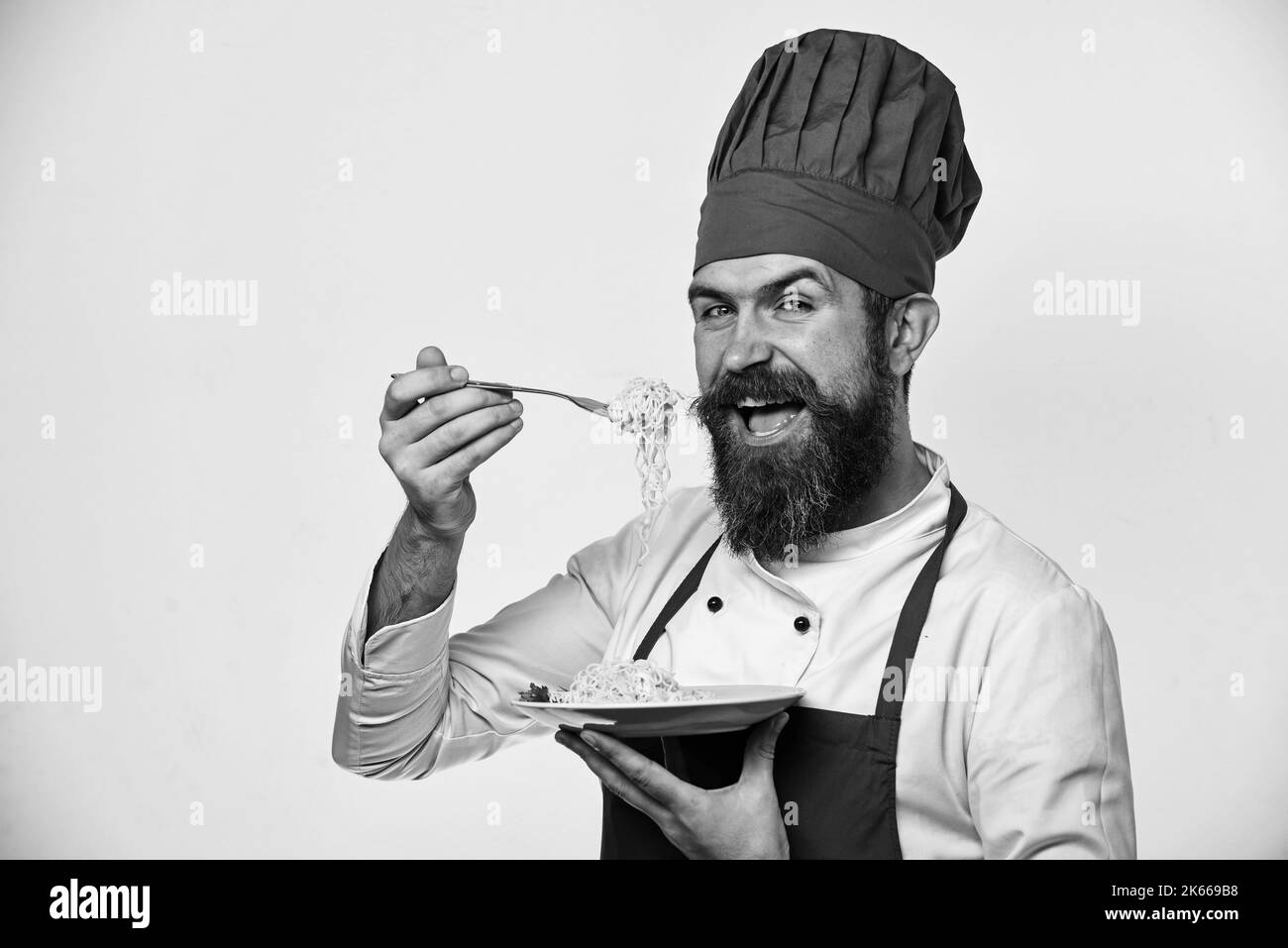 Chef eats italian or asian noodles. Cook with happy face Stock Photo ...