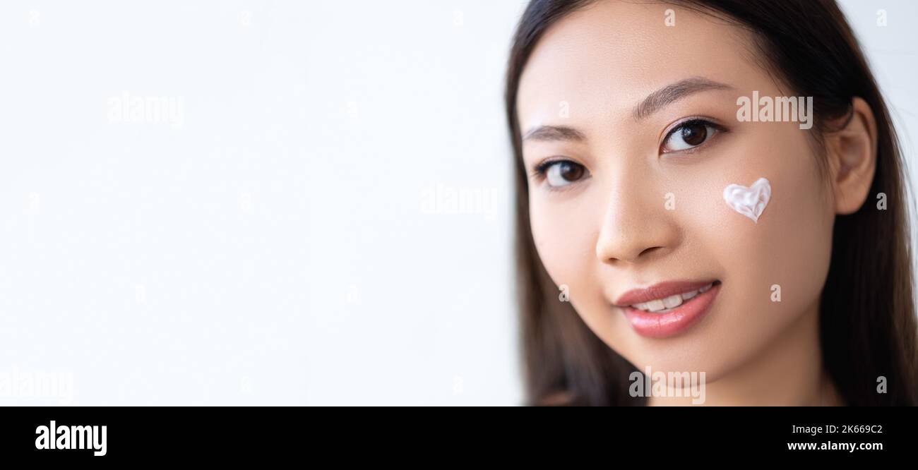 facial care skin moisturizing woman heart lotion Stock Photo - Alamy
